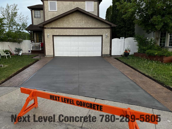 Tinted Grey Broom Finish Concrete Driveway - Next Level Concrete Ltd